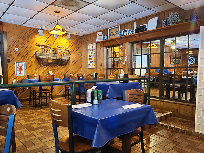 Nautical charm meets cozy comfort in this wood-paneled dining room. The lobster trap on the wall isn't just decoration&mdash;it's foreshadowing for your appetite.