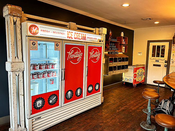 Inside, the vintage refrigerator case proudly displays pints of handcrafted flavors, a treasure chest of frozen gold.