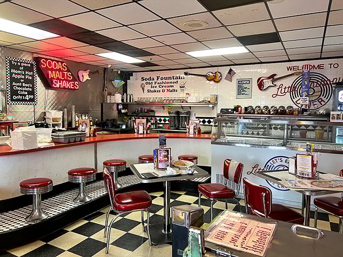 Step inside and the nostalgia hits harder than a jukebox playing "Rock Around the Clock." Red vinyl stools and checkerboard floors set the perfect stage.