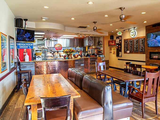 Rustic wooden tables and leather booths create that perfect "stay awhile" vibe. The counter's copper finish adds warmth that matches the golden-brown chicken they're famous for.