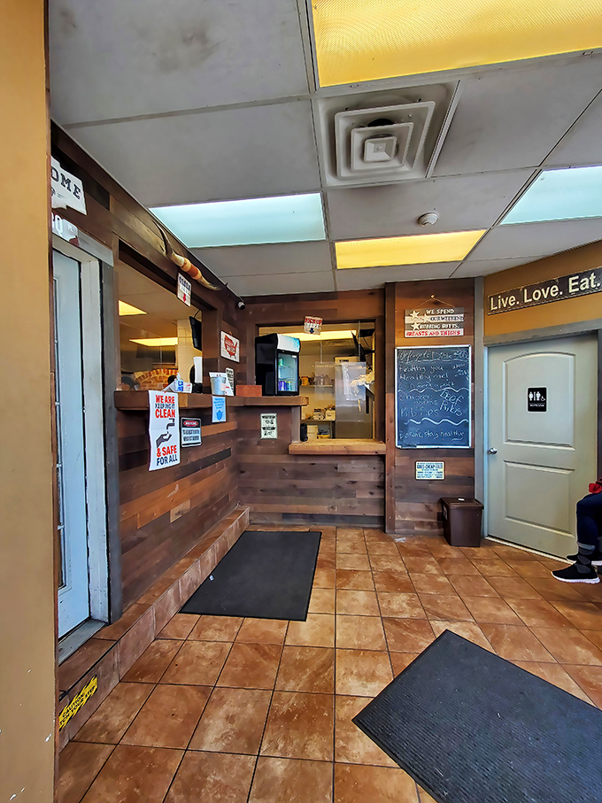 Step inside to no-frills wooden paneling, a simple counter, and that "Live. Love. Eat." sign that feels less like decor and more like a mission statement.