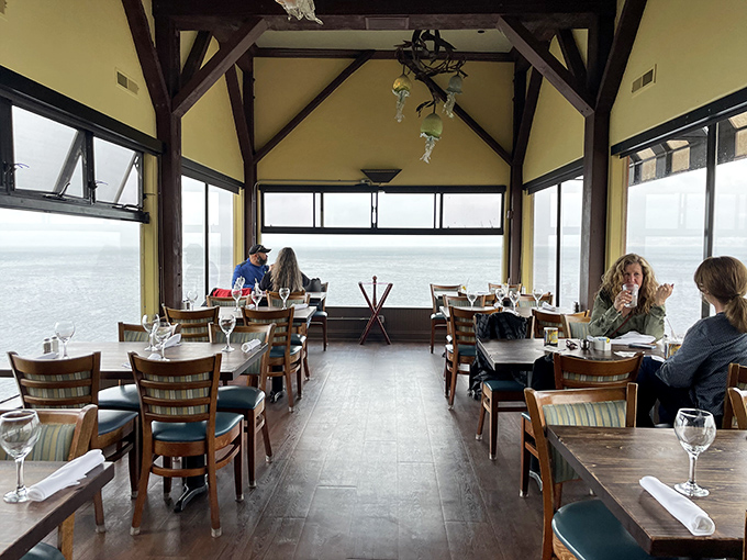 The dining room's floor-to-ceiling windows transform a simple meal into dinner theater, with the Pacific Ocean providing the ever-changing backdrop.