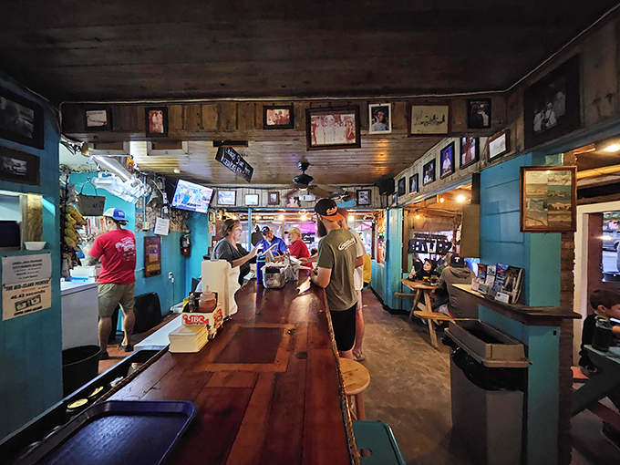 Inside Skinny's, wooden walls adorned with memories tell stories older than most Florida condo developments. This is where burger magic happens.