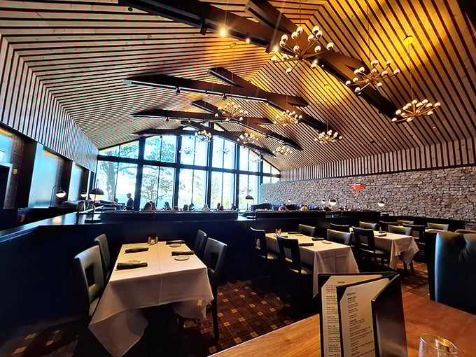 Soaring wooden ceilings and dramatic pendant lights create an atmosphere that's both grand and intimate &ndash; Wisconsin supper club elegance reimagined for today's diners.