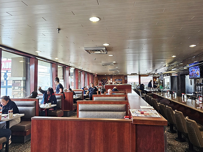 Classic diner booths where strangers become neighbors and calories don't count. The red vinyl has witnessed more heart-to-hearts than a therapist's couch.