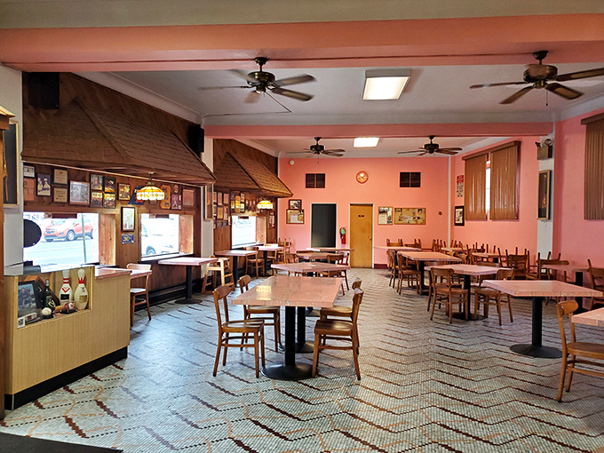 Pink walls and vintage tile flooring create a time capsule of American dining culture where conversations flow as freely as the coffee.