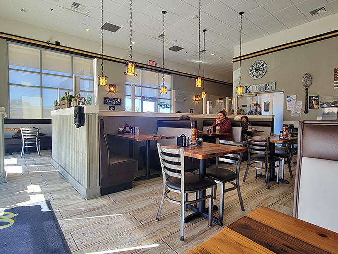 Pendant lights cast a golden glow over wooden tables where breakfast dreams come true, creating that "just right" ambiance between fancy and familiar.