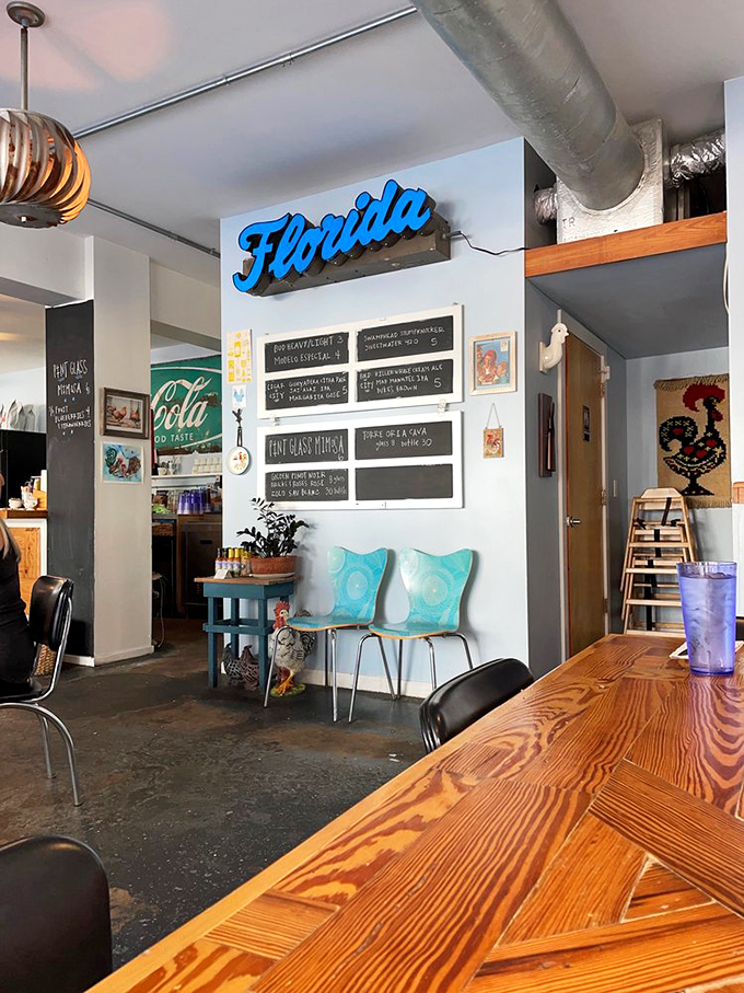 Inside, that glowing "Florida" sign isn't just decoration—it's a beacon guiding hungry souls to breakfast nirvana amid turquoise chairs and warm wood.