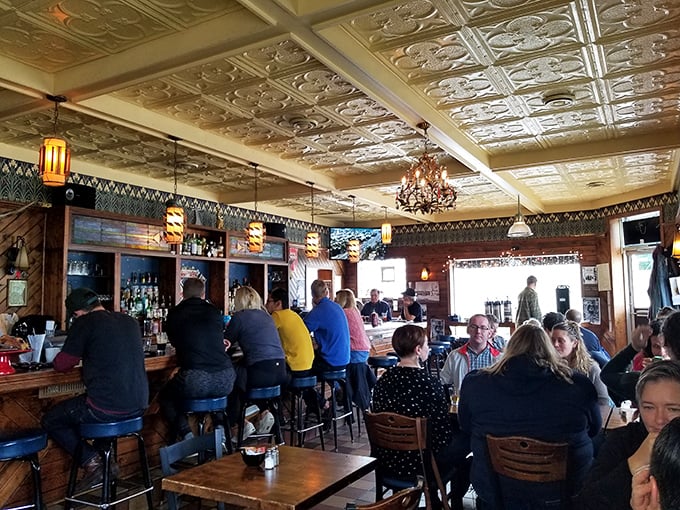 Beneath ornate tin ceilings and warm lighting, locals gather at the bar where conversations flow as freely as the Wisconsin craft beers.