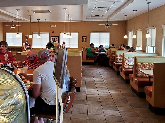 Cozy booths and warm lighting create that perfect diner atmosphere where strangers become friends and coffee cups never stay empty.