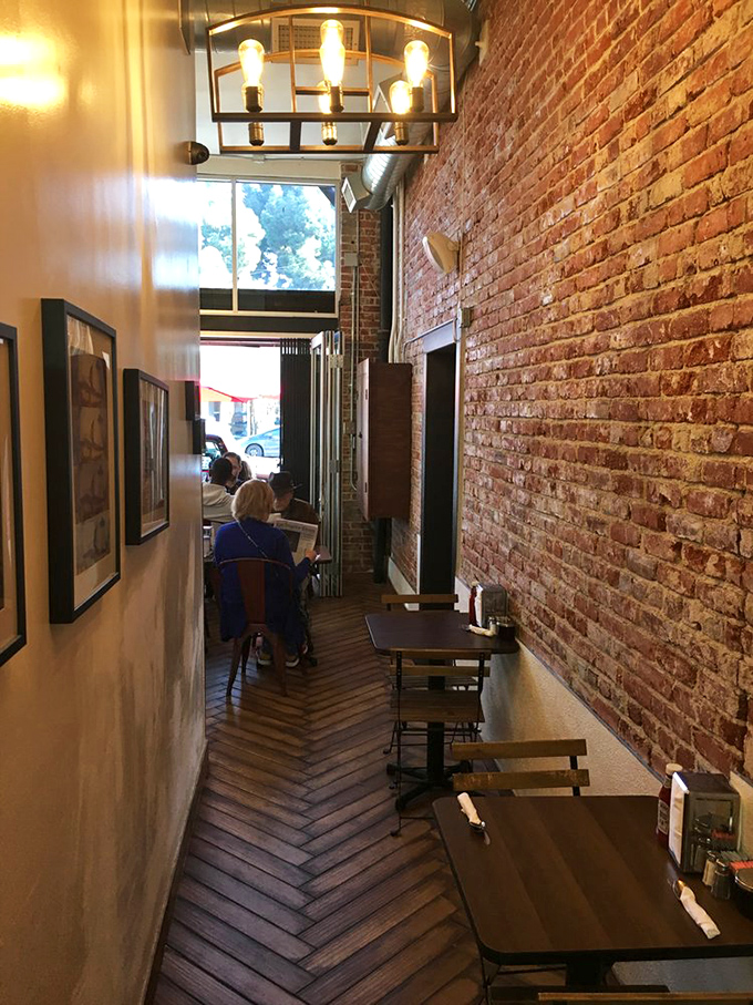 Exposed brick walls and herringbone floors create a cozy tunnel of deliciousness where breakfast dreams come true.