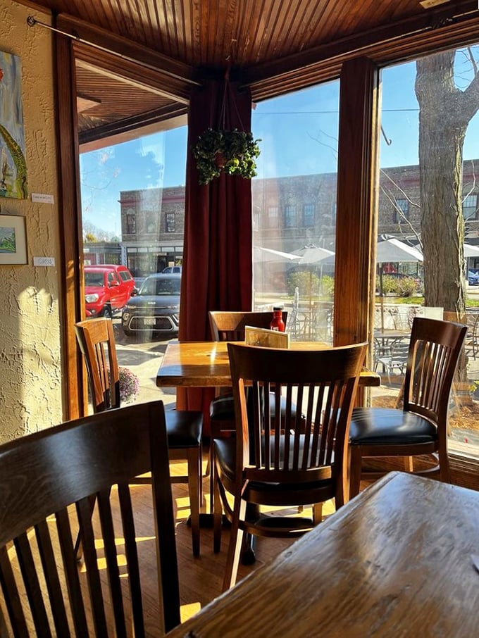 Sunlight streams through windows framing wooden tables where strangers become friends. This corner spot might be Madison's coziest conversation starter.