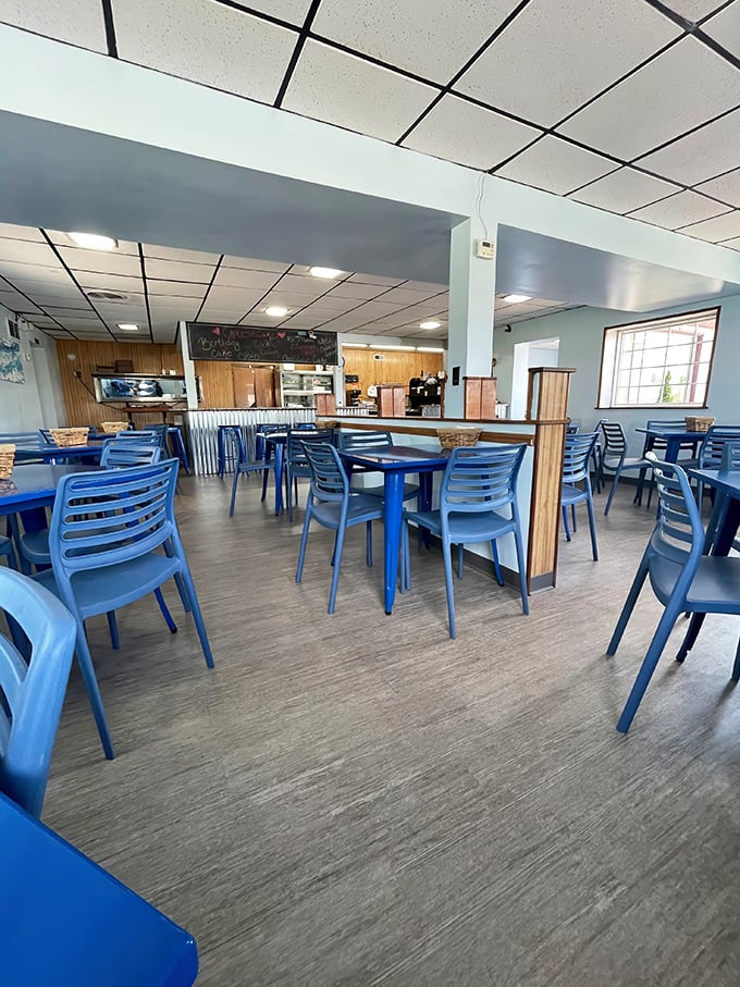 Blue chairs and wooden accents create a no-nonsense dining room where the food, not the decor, takes center stage. Simplicity with purpose.