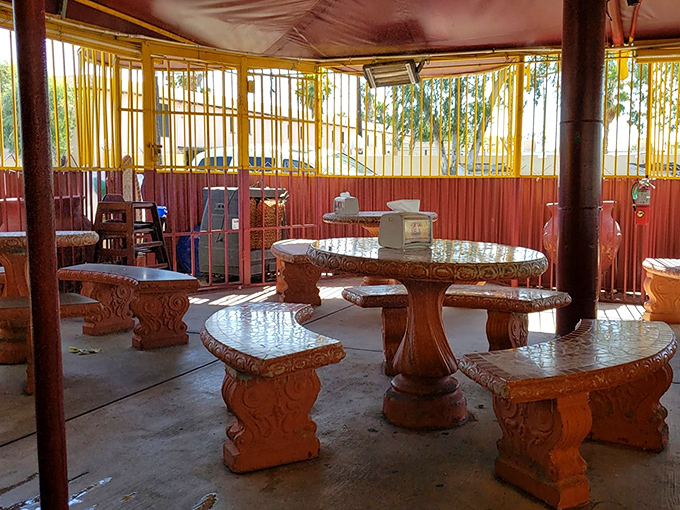 Stone tables and benches create a backyard patio vibe inside. This no-frills dining area says, "We put our energy into the food, not fancy furniture."