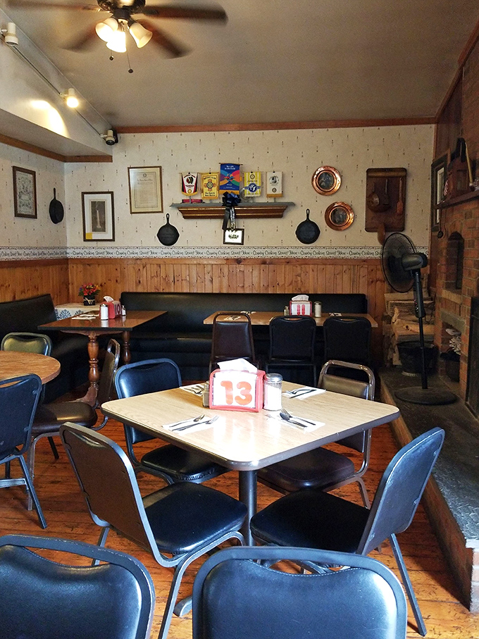 Inside, cast iron skillets adorn walls above wooden paneling, creating that rare atmosphere where you instantly know you've found somewhere special.