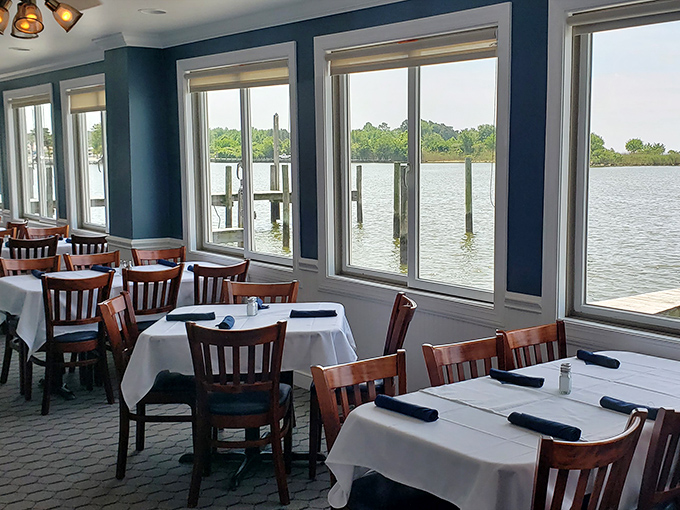 Blue walls echo the Chesapeake waters visible through panoramic windows. The dining room offers front-row seats to nature's aquatic theater while you feast.