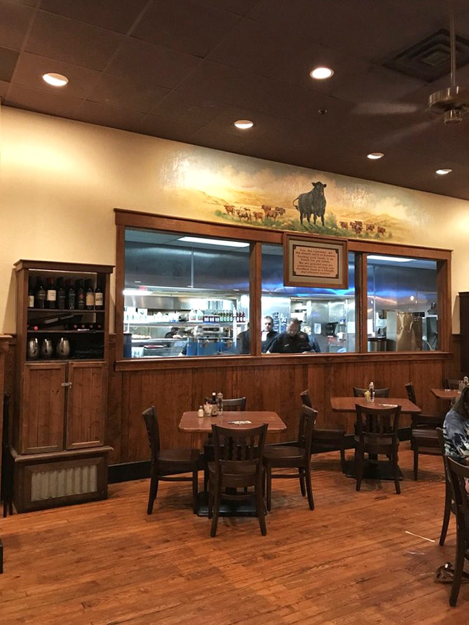 A peek into the kitchen reveals where the magic happens, with a cattle mural above reminding you exactly why you came – for serious steak business.