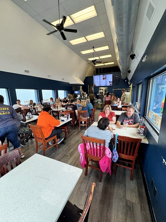 Inside, navy blue walls and wooden chairs create the perfect backdrop for culinary magic. No pretension here, just a space designed for serious eating.