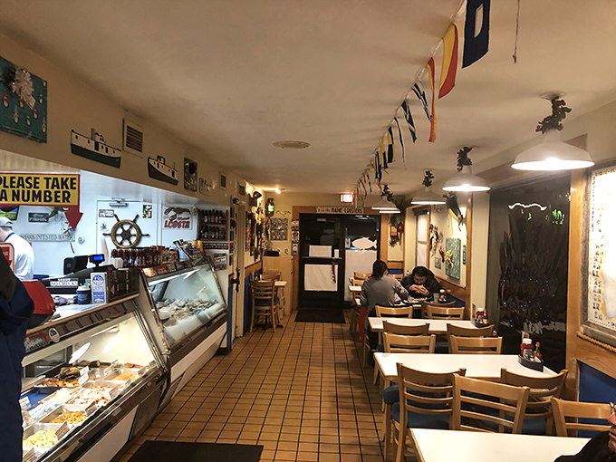 Nautical flags dance overhead while ship wheels stand sentinel on walls&mdash;this isn't just decoration, it's a promise of maritime delights to come.