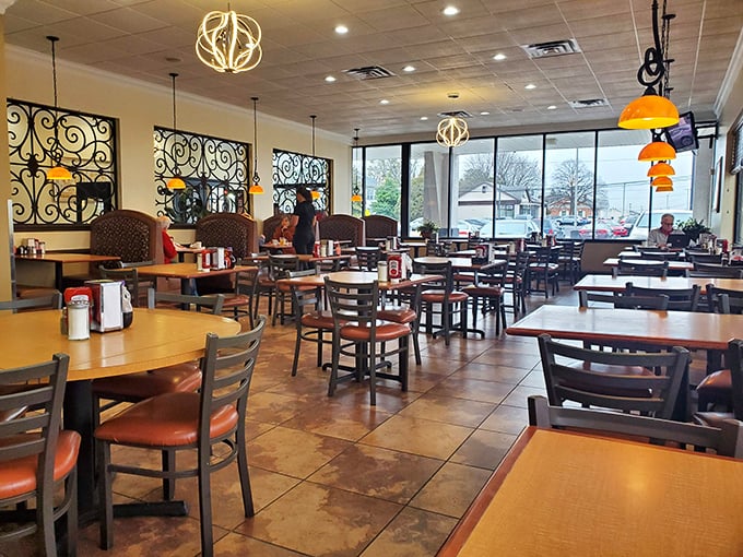 Warm pendant lighting and those distinctive wrought iron dividers create the perfect balance of privacy and community&mdash;diner design at its finest.