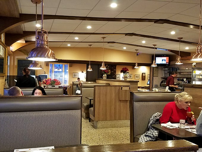 Cozy booths and warm lighting create that perfect diner atmosphere where conversations flow as freely as the coffee.