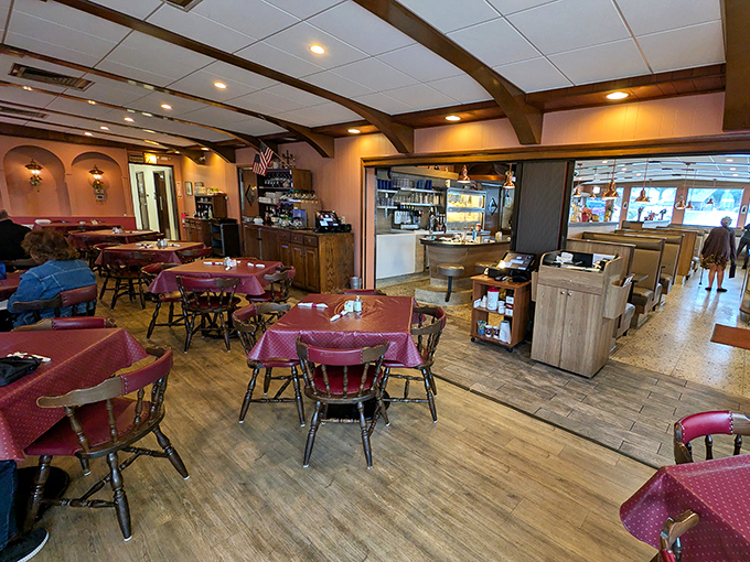 Step inside and you're transported to a world where burgundy tablecloths and wooden beams create the perfect backdrop for comfort food conversations.