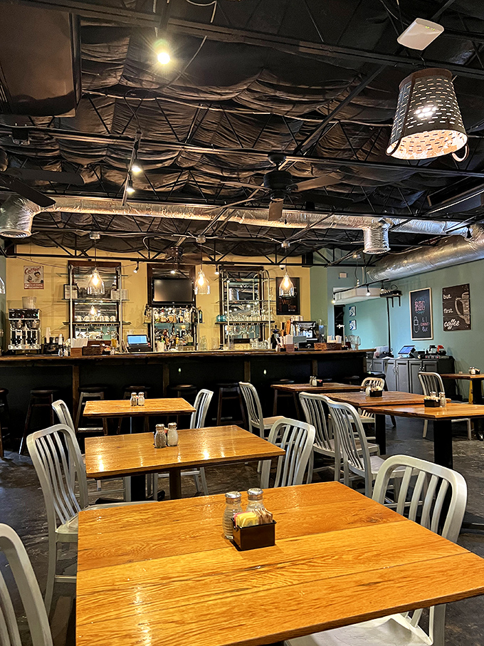 Industrial meets homey in this dining space where wooden tables and metal chairs create the perfect backdrop for morning conversations and coffee refills.