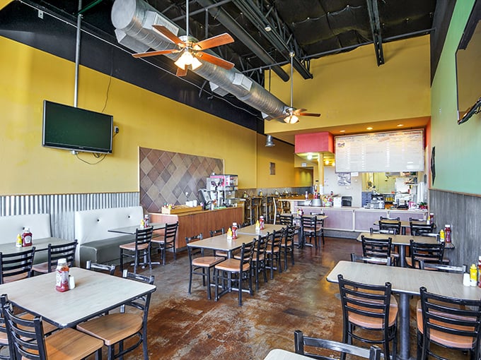Yellow walls and exposed ductwork create that perfect "focus-on-the-food" atmosphere. No distractions from burger bliss here.