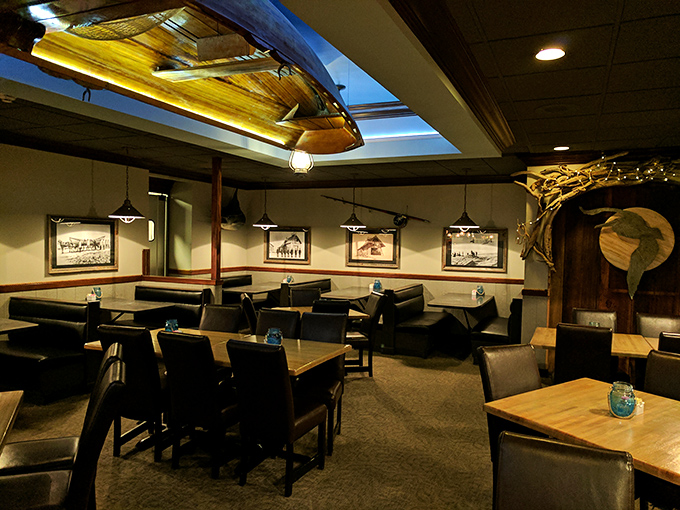 Nautical elegance meets cozy dining under a suspended wooden boat. History hangs from the ceiling while comfort awaits below.