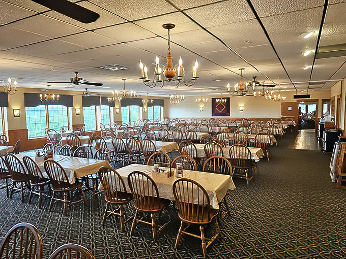 Step into dining room comfort where chandeliers meet checkered tablecloths in perfect harmony.