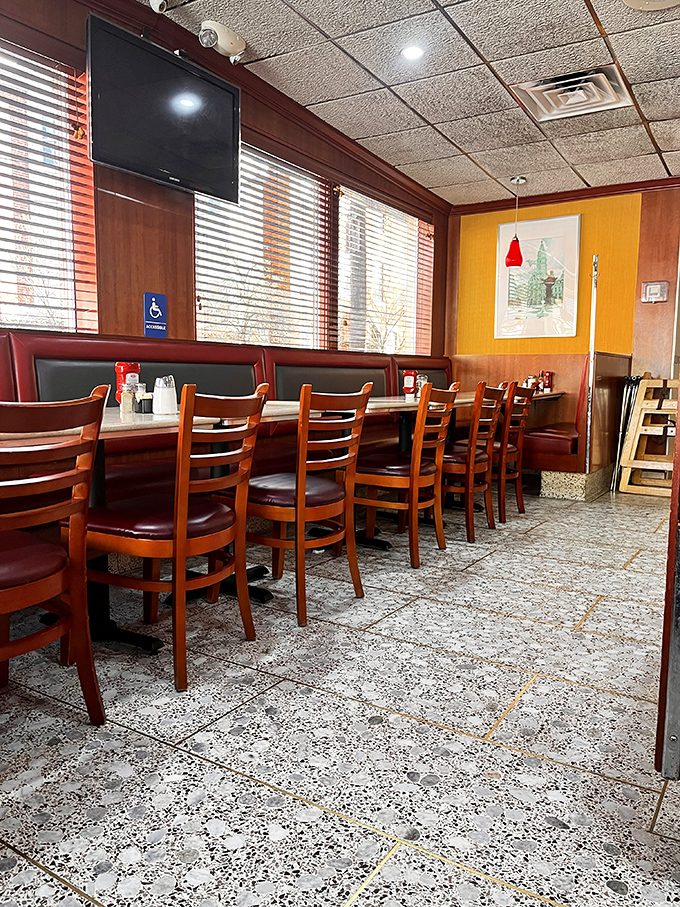 Burgundy booths and wooden chairs create that perfect diner atmosphere where conversations flow as freely as the coffee. Comfort never goes out of style.