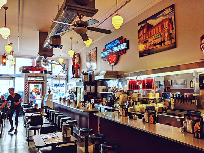 Counter culture at its finest! The gleaming diner interior with its classic stools and neon glow creates the perfect stage for culinary nostalgia.