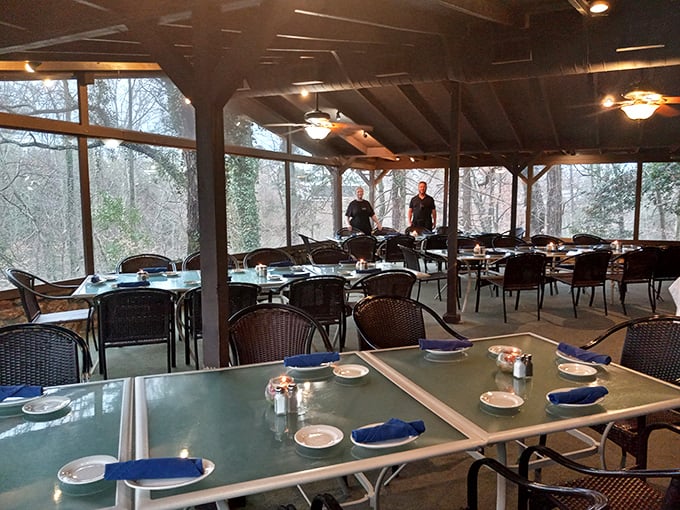 Nature becomes part of the dining experience in this glass-enclosed porch, where forest views complement every bite and conversation flows as freely as the iced tea.