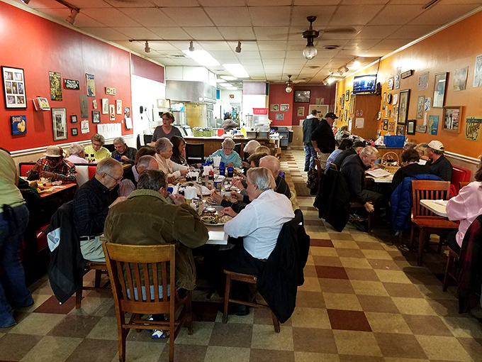 The checkered floor and colorful walls create the perfect backdrop for regulars who've been claiming "their booth" for decades.