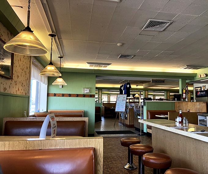 Step inside and the mint-green walls, pendant lights, and vinyl booths whisper tales of decades of satisfied diners and countless "best burger" debates.