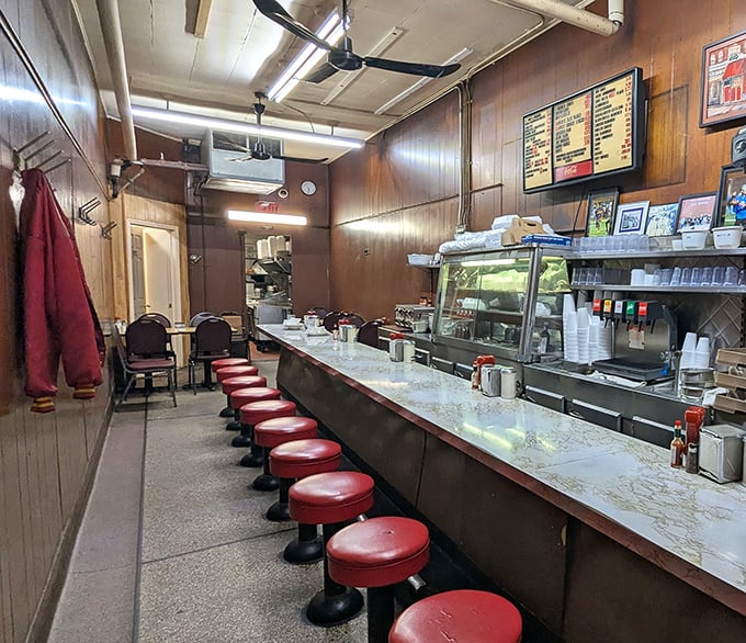 The counter where dreams come true. Those red vinyl stools have supported the weight of Detroit's history and countless satisfied diners seeking coney perfection.