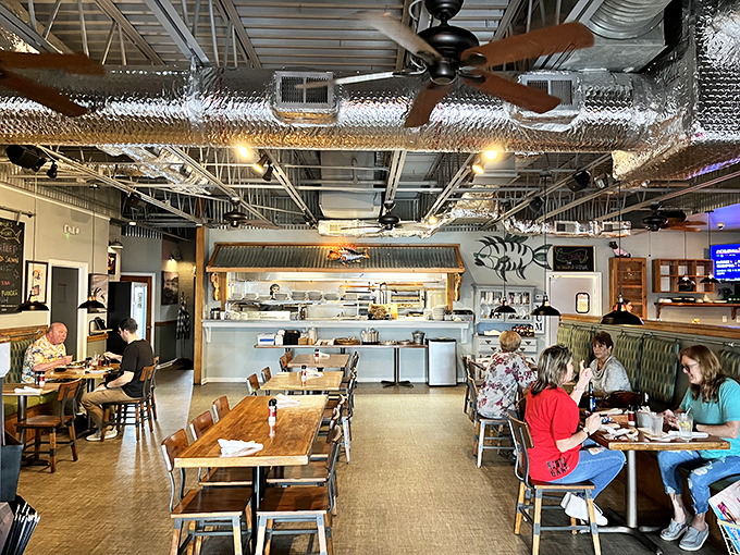 Inside, exposed ductwork meets nautical charm as diners gather around wooden tables, creating that perfect "I've discovered something special" atmosphere.