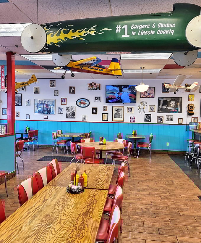Model airplanes soar above diners while classic photos line turquoise walls. The green derby car overhead boldly claims "#1 Burgers & Shakes" &ndash; a challenge I'm happy to investigate. 