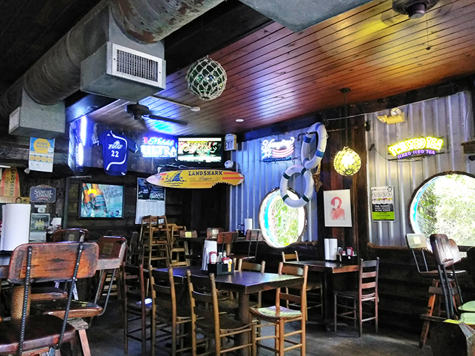 Where neon meets nautical. The interior's weathered wood, fishing nets, and college pennants create that perfect "I've discovered something special" vibe.