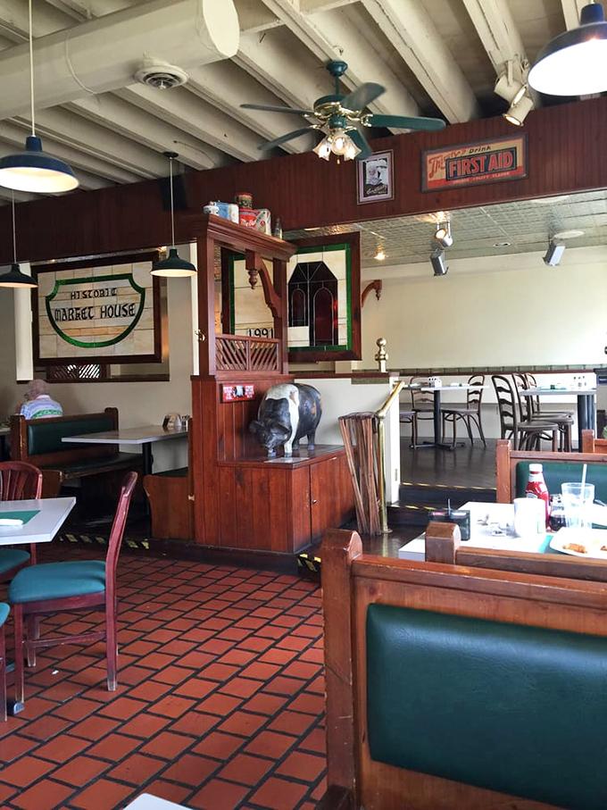 Step inside and you're greeted by warm wooden booths, terra cotta floors, and that unmistakable feeling that you've discovered somewhere special. The hippo statue? That's just bonus charm.