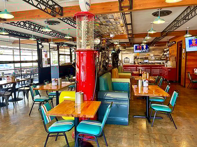 Retro meets rustic in this dining room where vintage gas pumps and motorcycles share space with turquoise chairs&mdash;a roadside Americana fever dream.
