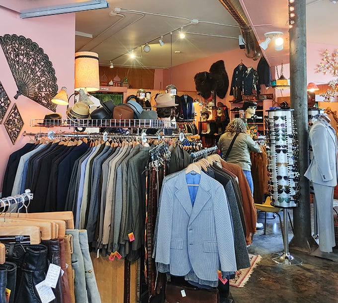 Pink walls and carefully curated racks create the perfect backdrop for treasure hunting. This isn't chaos—it's organized fashion archaeology at its finest.