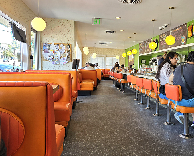 Step inside to a symphony of orange vinyl booths and globe pendant lights. This isn't manufactured nostalgia&mdash;it's the real deal that's survived decades.