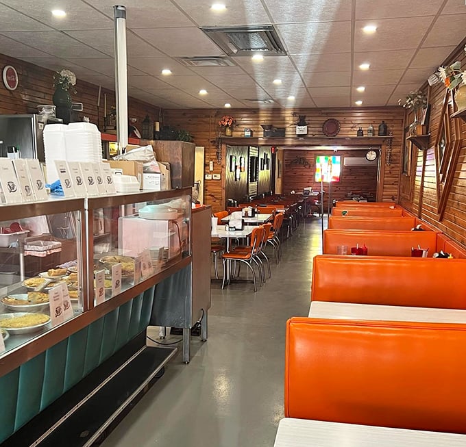 Inside, those iconic orange booths have witnessed decades of conversations, celebrations, and first bites of legendary pie that make eyes widen with delight.