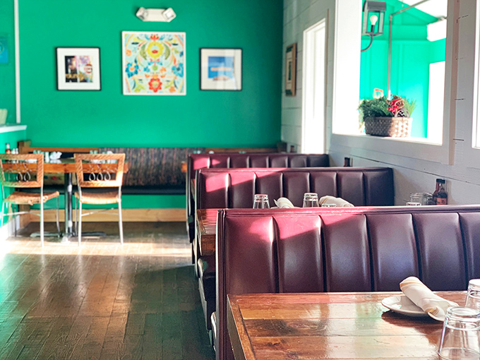 The vibrant green walls and burgundy booths create the perfect backdrop for both intimate date nights and boisterous family gatherings.