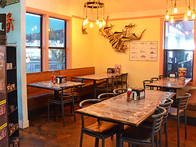 Rustic charm meets maritime magic inside, where metal fish sculptures swim across the walls and Edison bulbs cast a warm glow over conversations worth savoring.