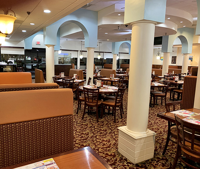 Step inside and you're transported to a world where Mediterranean-inspired architecture meets classic American comfort. Those columns aren't holding up just the ceiling, but decades of dining memories.