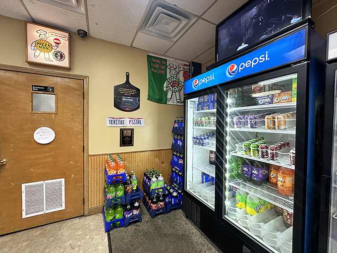 No fancy frills here—just wood paneling, a well-stocked beverage cooler, and an atmosphere that puts all focus where it belongs: on the legendary pizza.