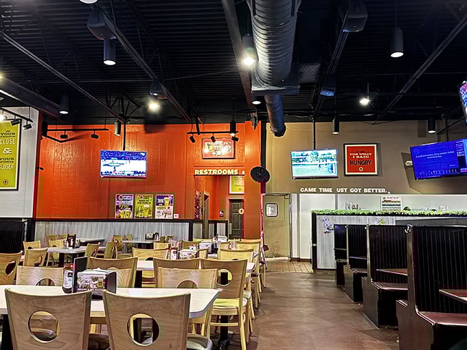 Orange walls and wooden chairs create that perfect "come as you are" vibe where both families and sports fanatics feel equally at home.