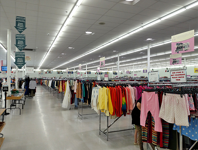 Rainbow-organized clothing racks stretch as far as the eye can see, like a department store where everything comes with a backstory.